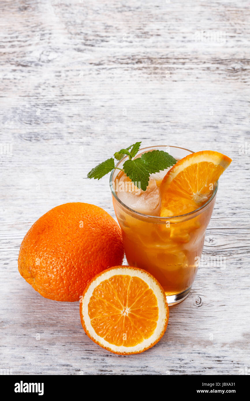 Fresh and cold ice tea with sliced orange and mint Stock Photo - Alamy