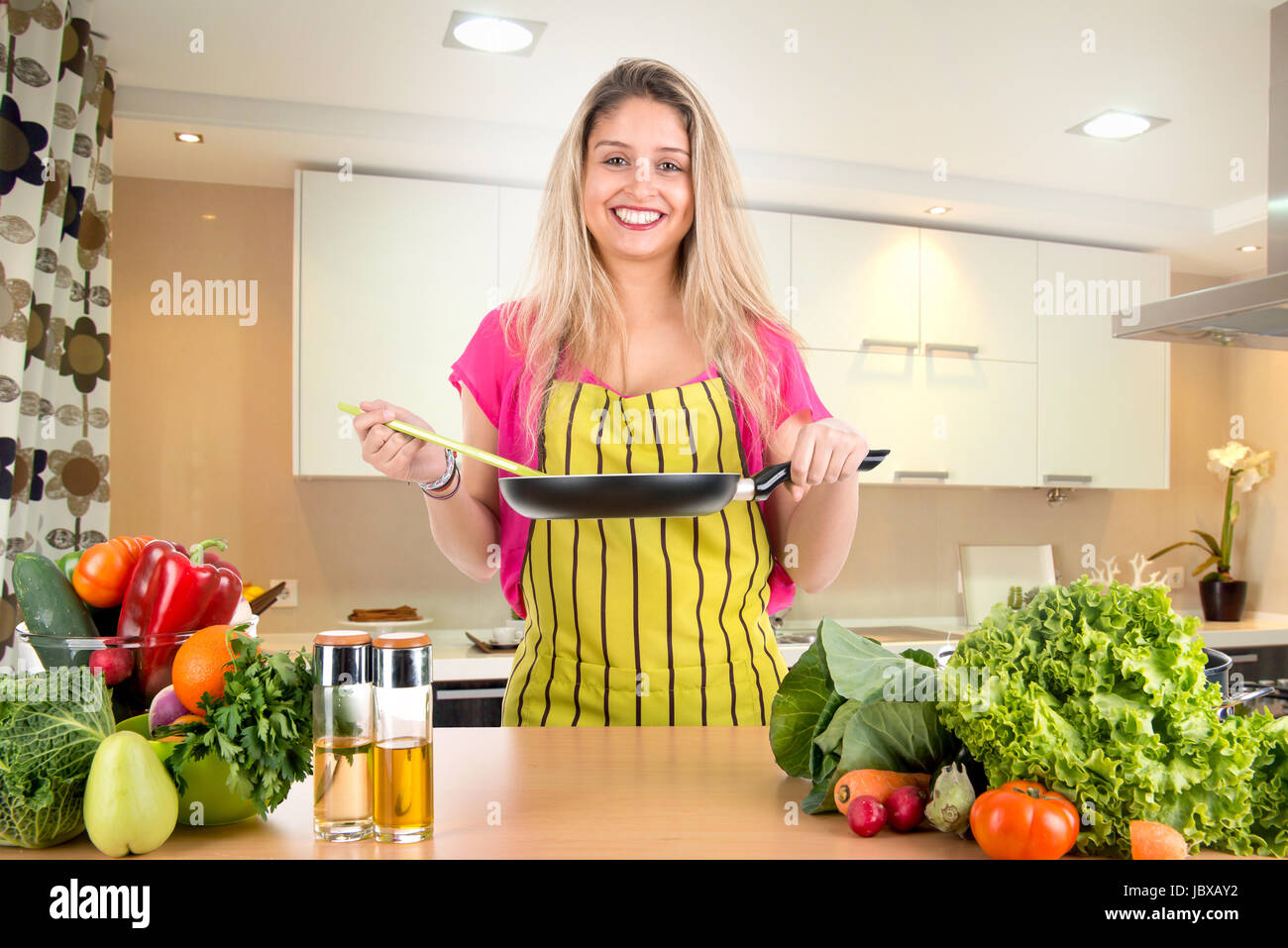 Beautiful woman cooking in the kitchen Stock Photo - Alamy