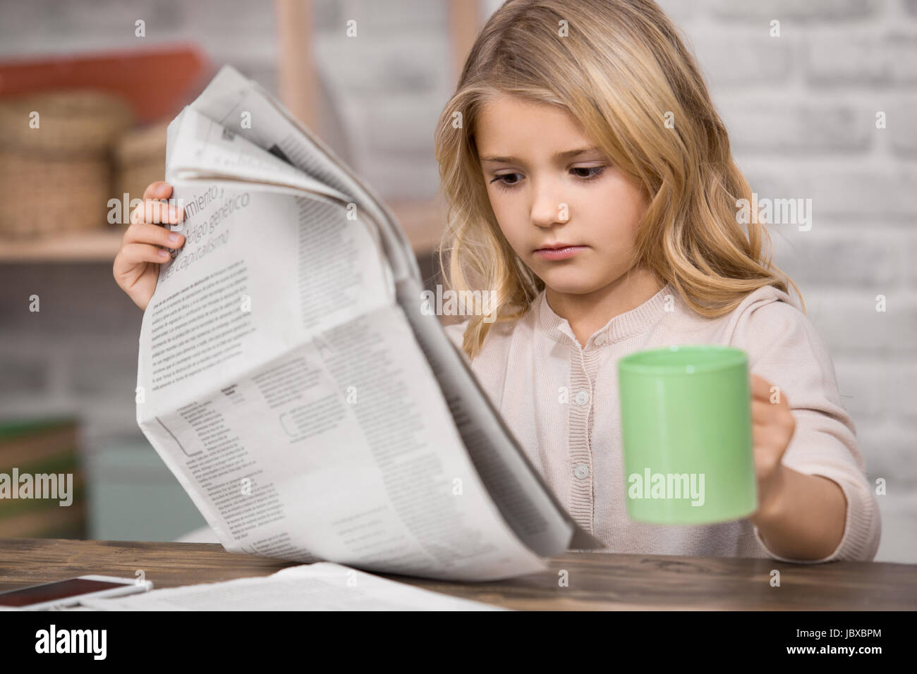 Little girl reading paper study knowledge information Stock Photo - Alamy