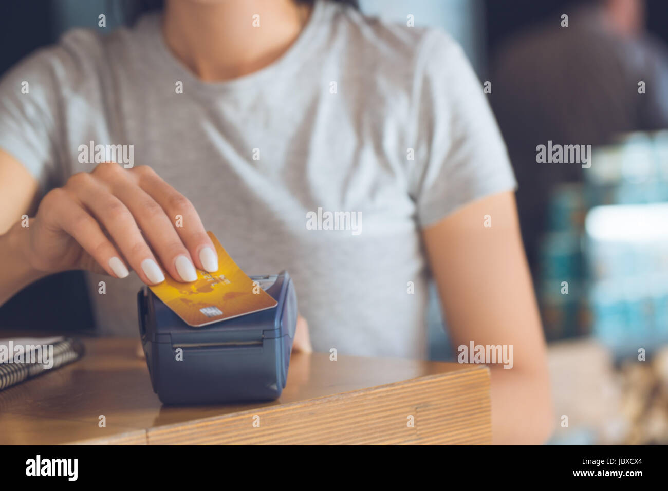 Young female sitting in a cafe indoors rest cashless payment Stock ...