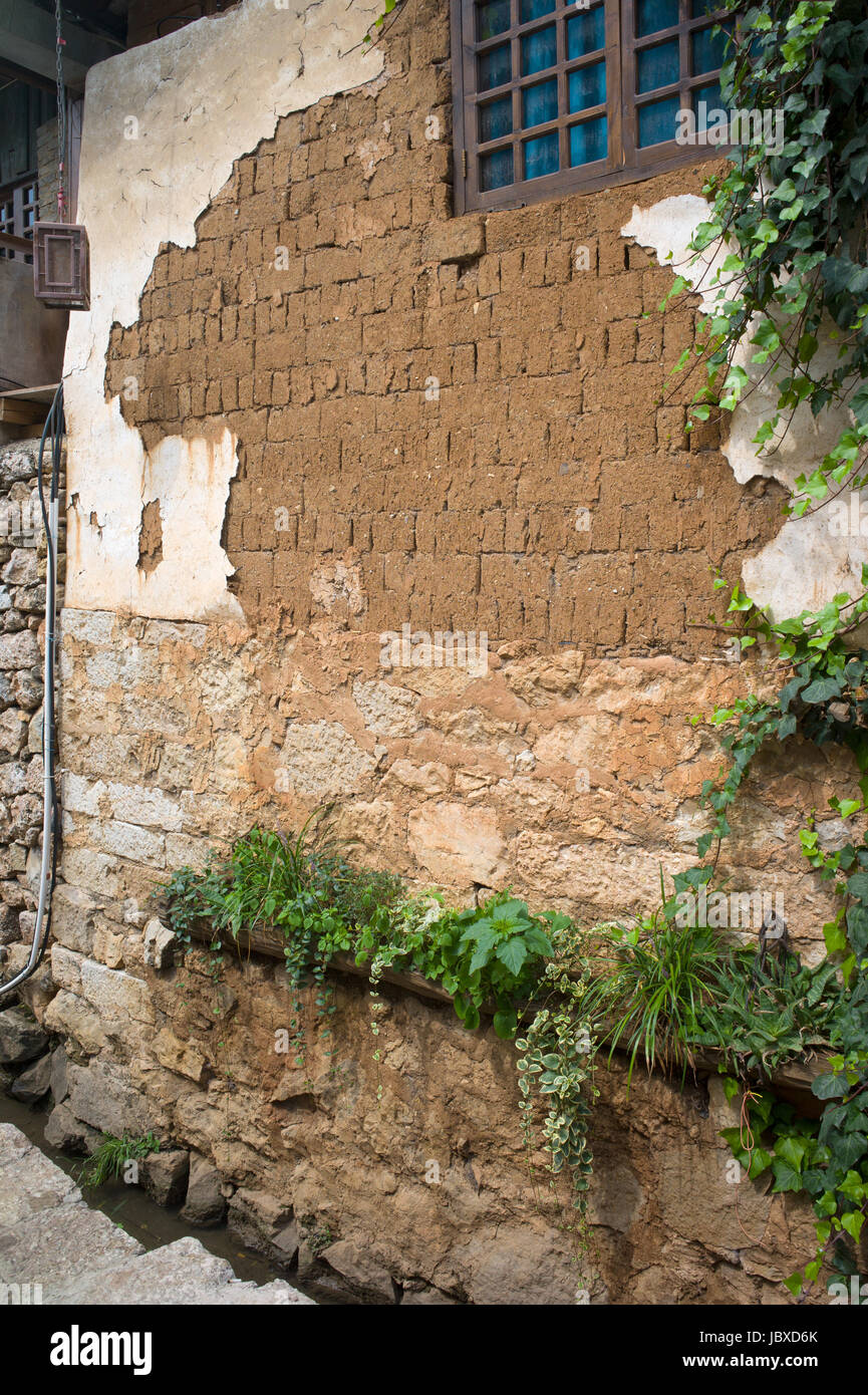 Mud bricks and stone wall of house, Lijiang, Yunnan, China Stock Photo ...