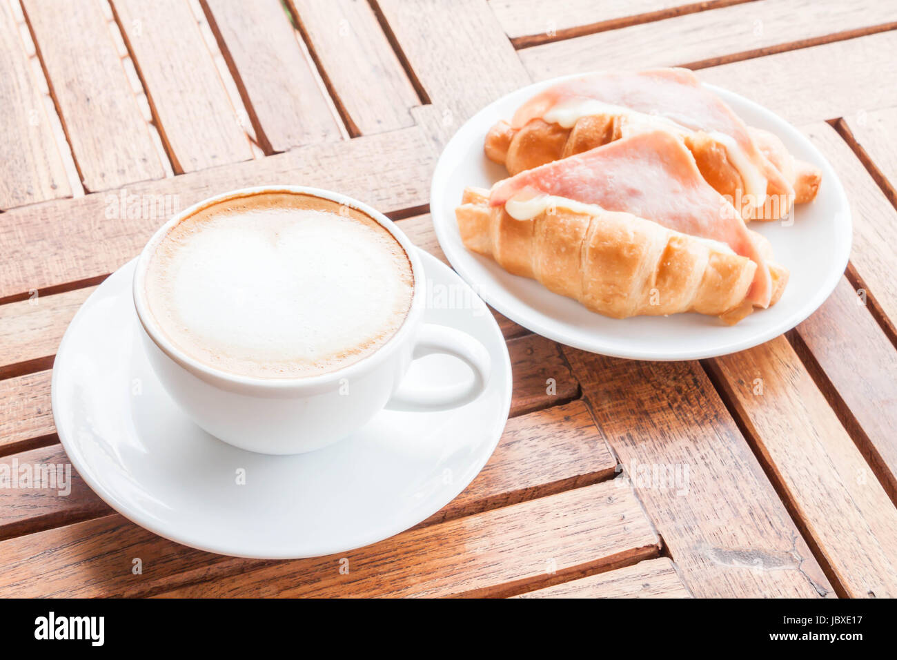 Meal set of coffee latte and croissants Stock Photo - Alamy