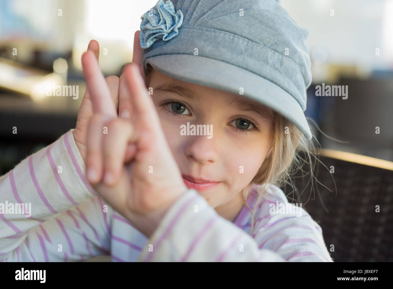 Cute girl showing horn signs with both hands Stock Photo - Alamy