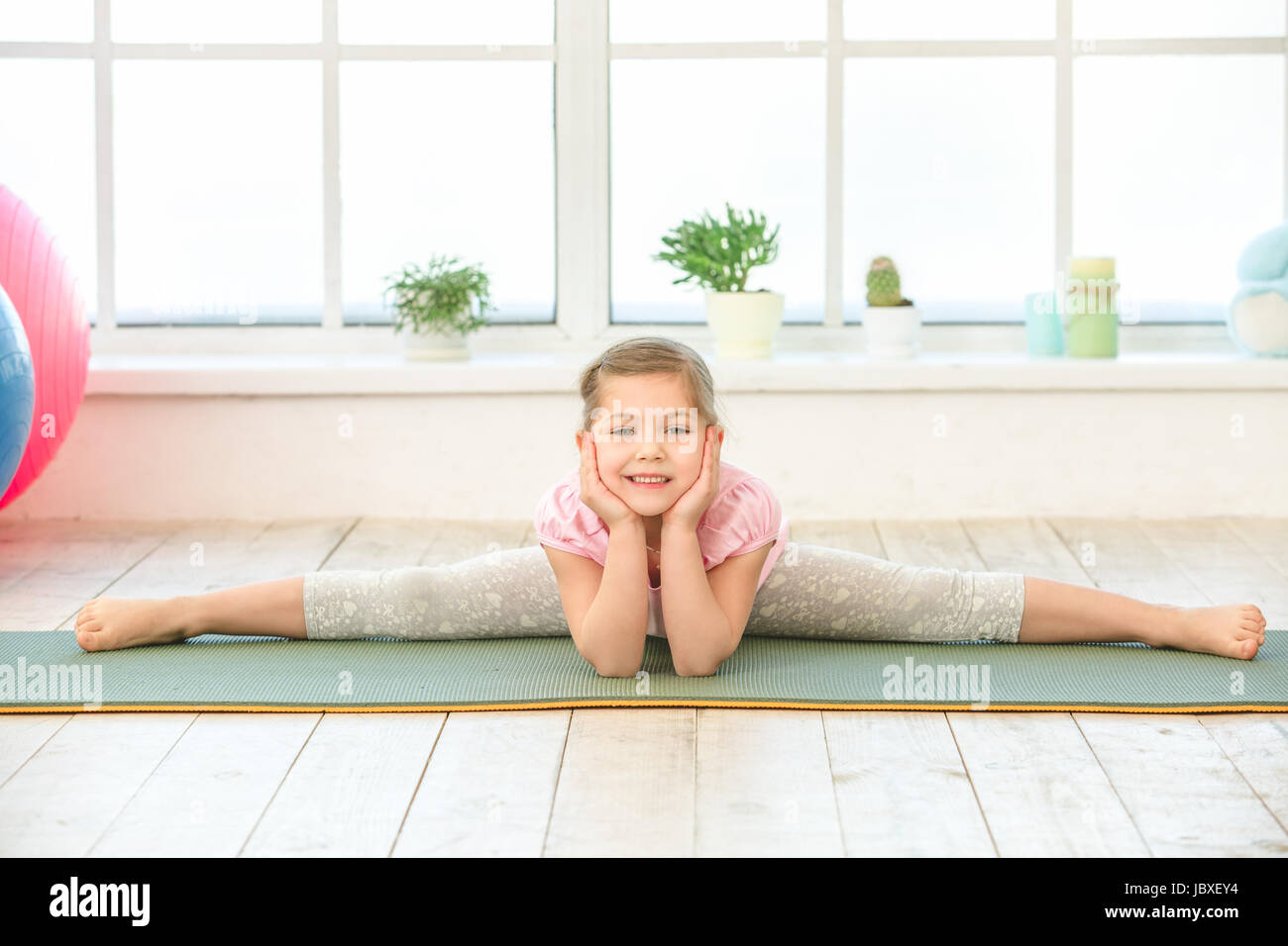 Little child girl exercise in the morning indoors Stock Photo - Alamy