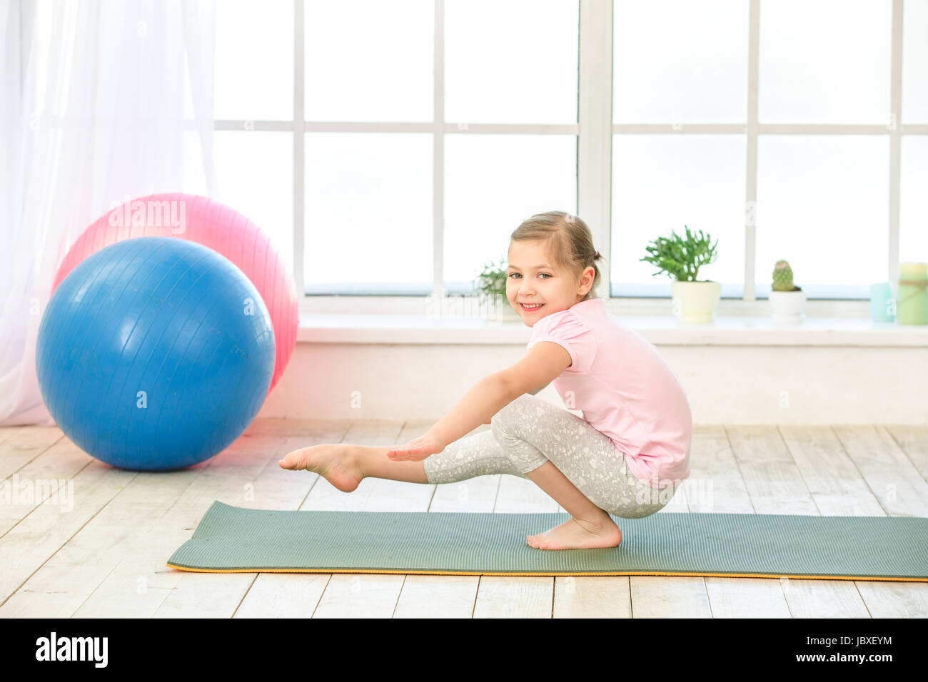 Little child girl exercise in the morning indoors Stock Photo - Alamy