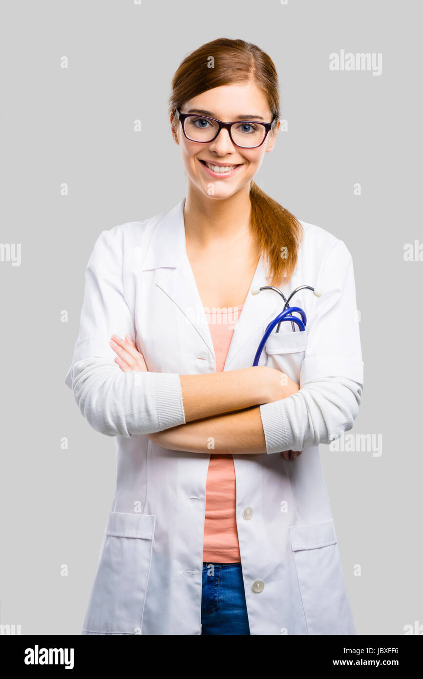 Beautiful and attractive female doctor, isolated over a white ...