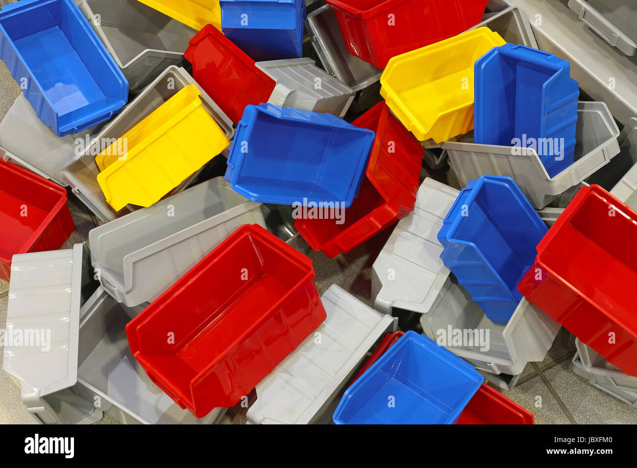 Big bunch of colorful plastic sorting bins and tubs Stock Photo - Alamy