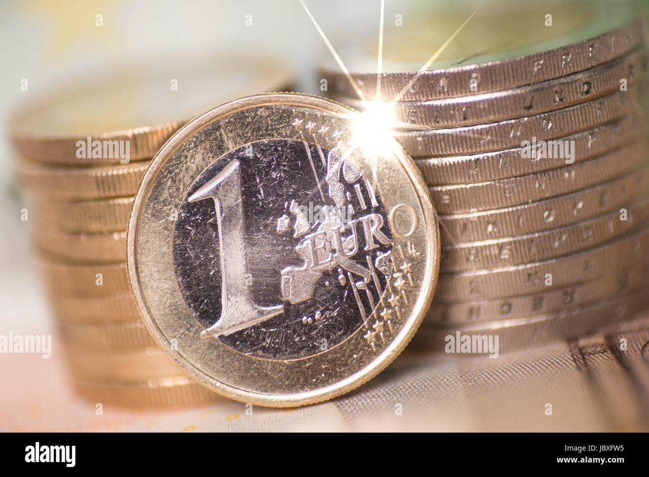sparkling Euro coin with coin stack Stock Photo - Alamy