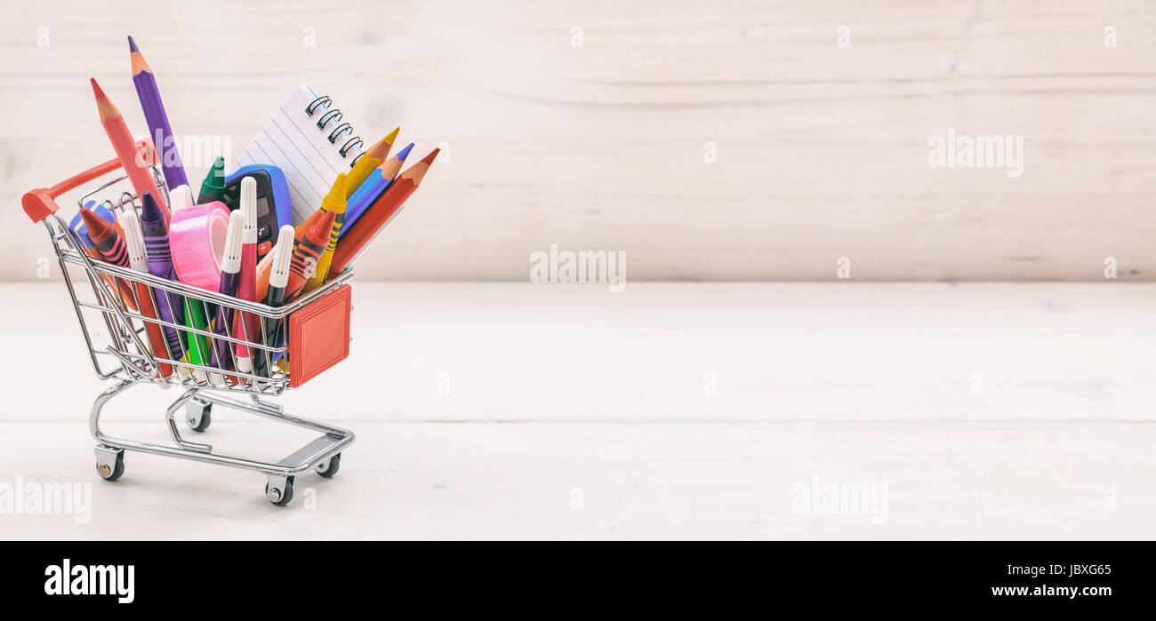 School supplies in a shopping cart on white background Stock Photo - Alamy
