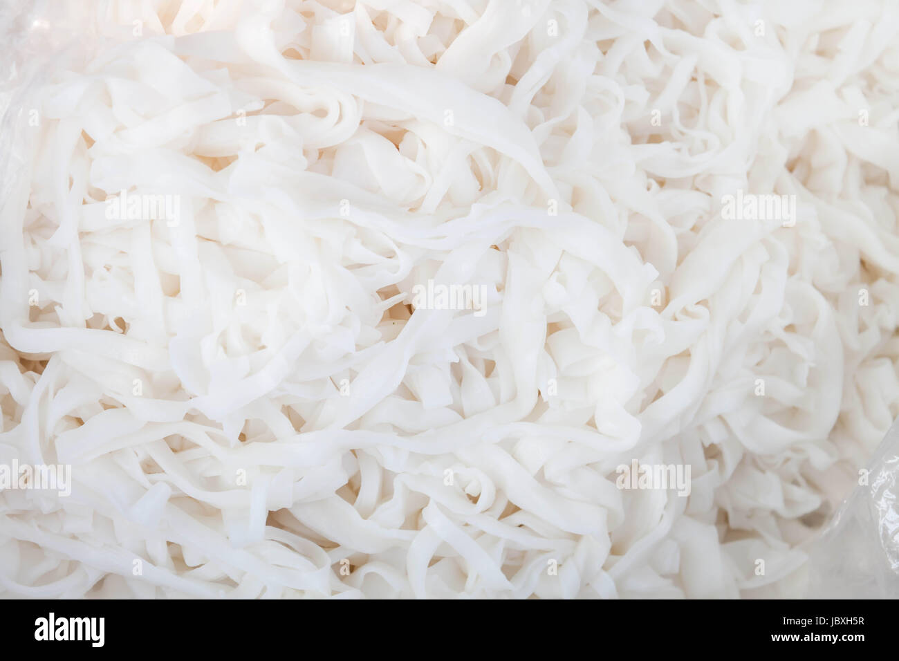 Asian white rice noodles close up background Stock Photo - Alamy