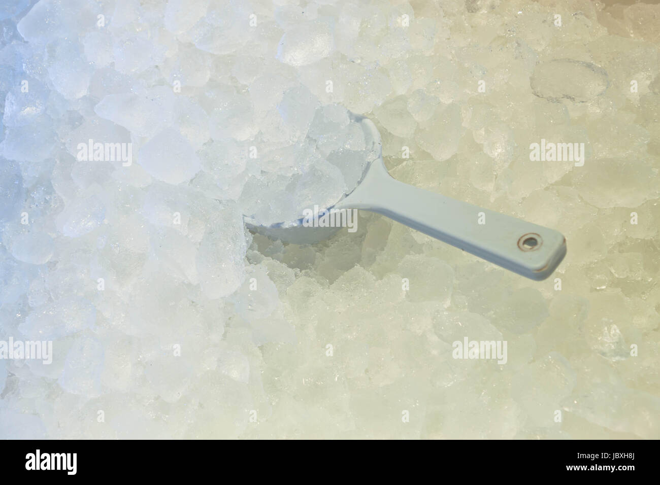 Ice spoon in fresh cool ice background Stock Photo - Alamy
