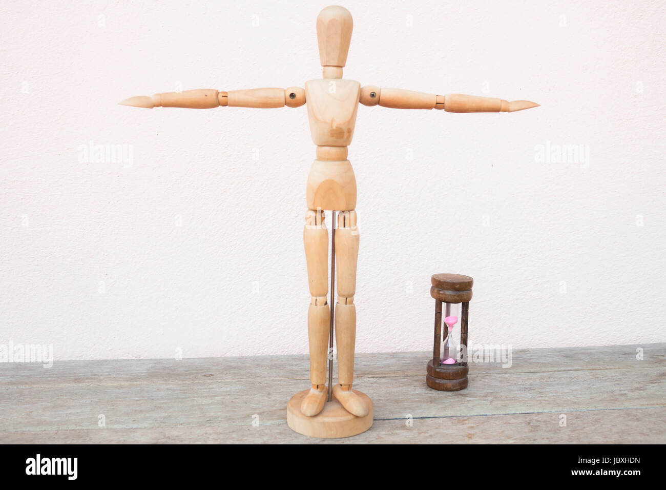 Wooden mannequin extend the arms of count down Stock Photo - Alamy