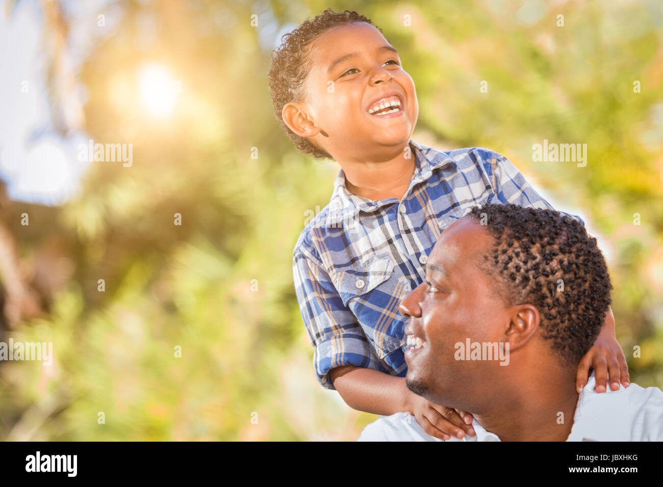 Mixed Race Son And African American Father Playing Outdoors Together
