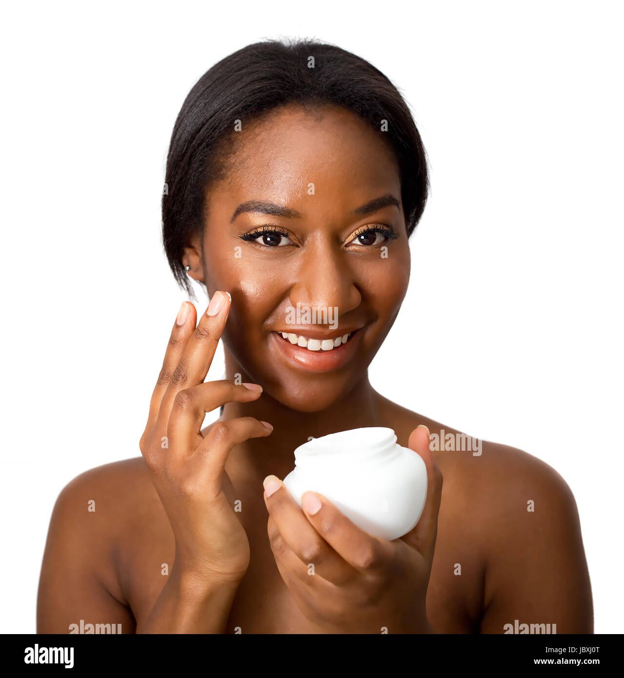young african american woman applying cream to her face Stock Photo - Alamy