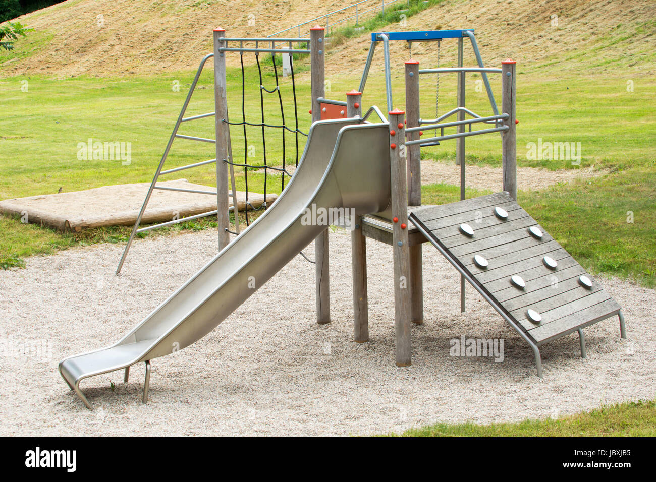Playground with a slide and climbing frame Stock Photo - Alamy