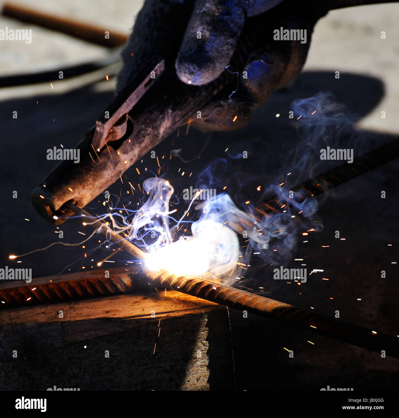 Sparks from welding on a dark background Stock Photo - Alamy