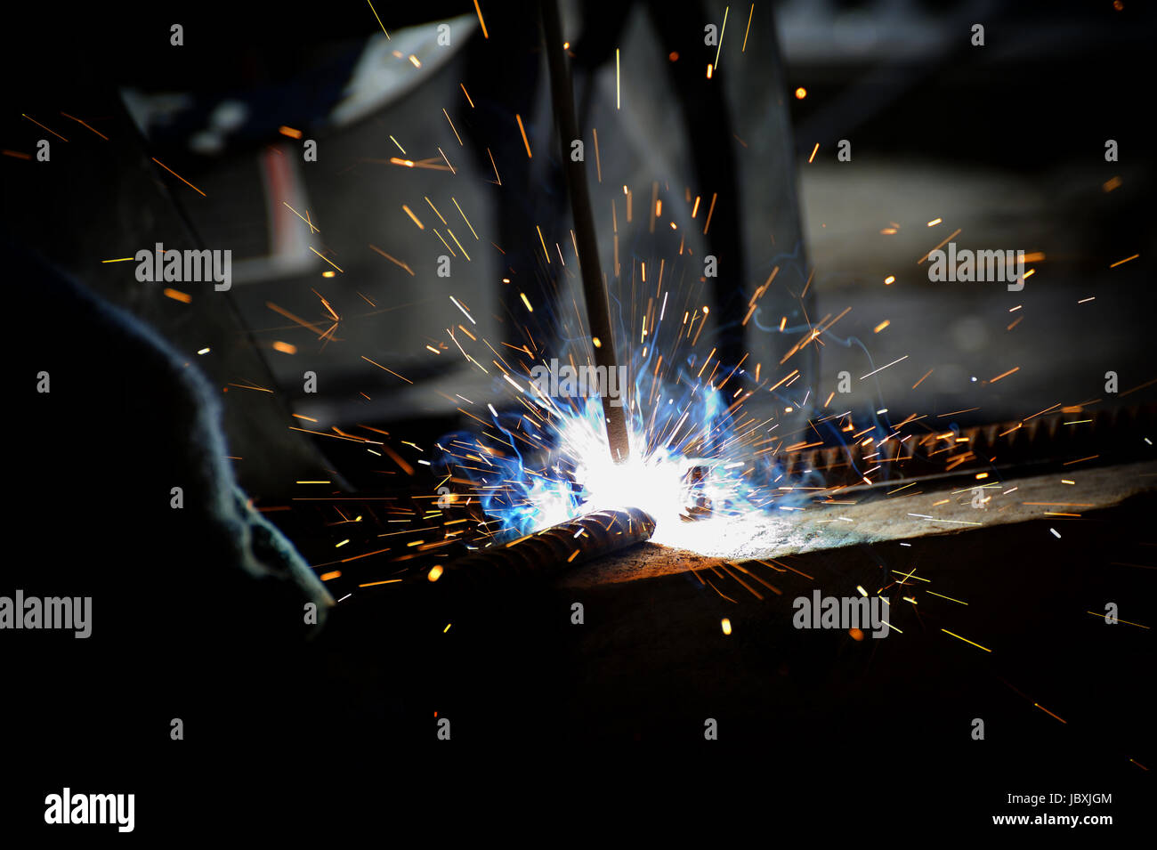 Sparks from welding on a dark background Stock Photo - Alamy