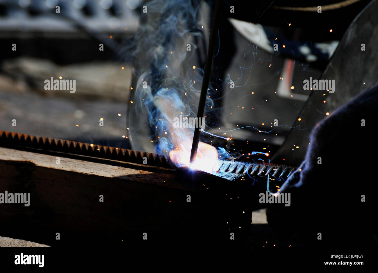 Sparks from welding on a dark background Stock Photo - Alamy