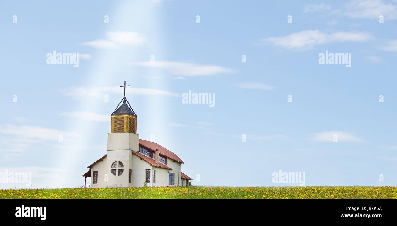 christian church on green field with light beam Stock Photo - Alamy
