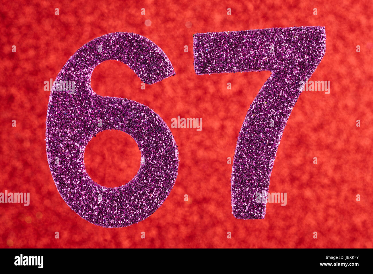Number sixty-seven purple color over a red background. Anniversary ...