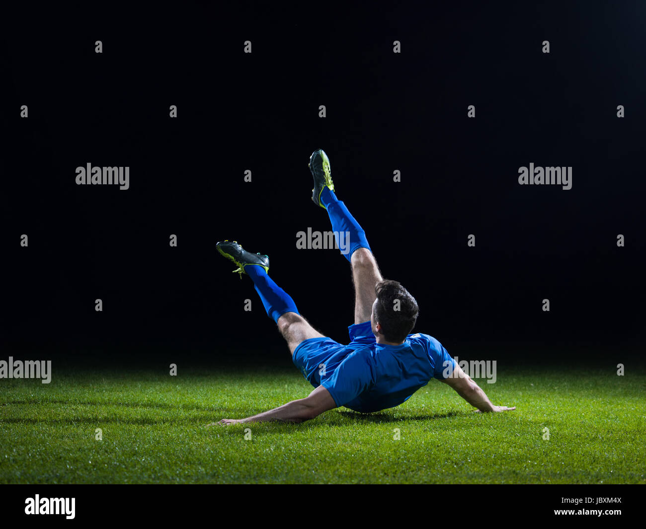 soccer player doing kick with ball on football stadium field isolated on black background Stock ...