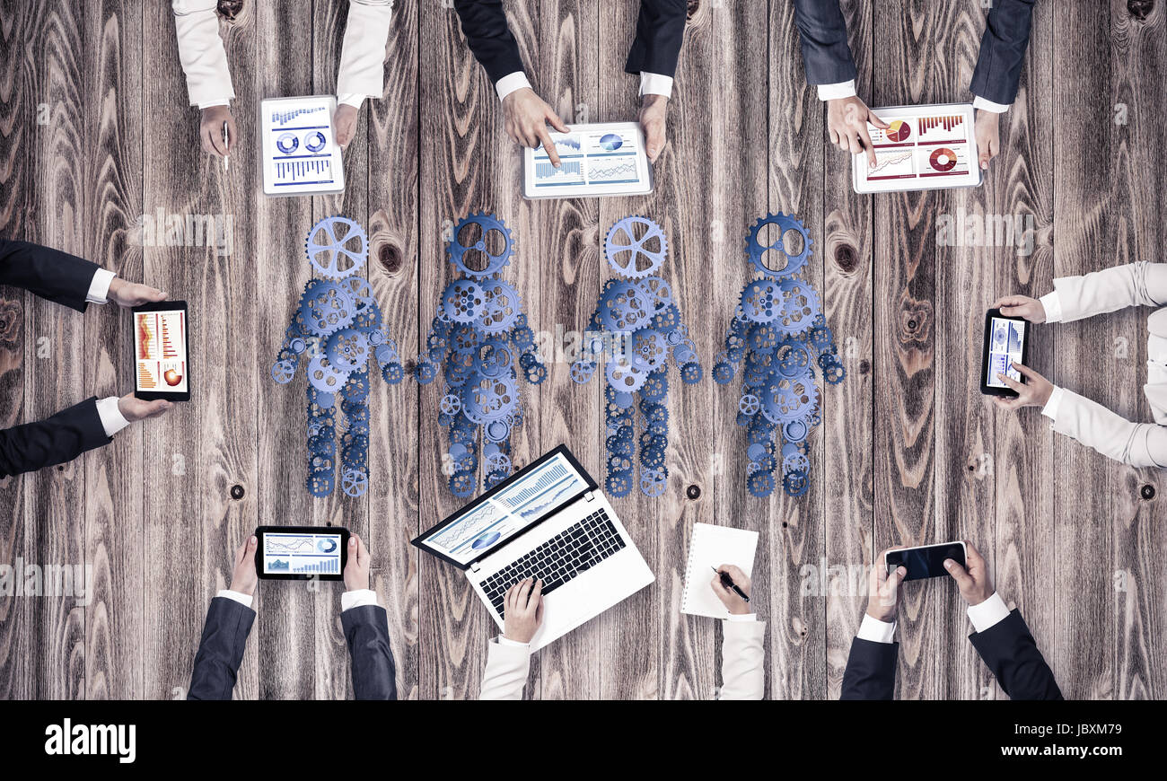 Group of people with devices in hands working together as symbol of ...