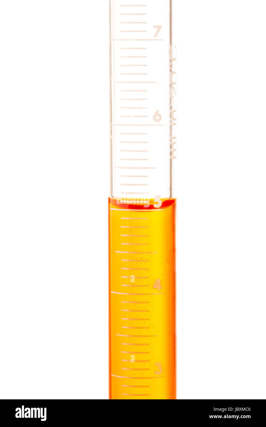 Measuring 5 ml of orange liquid in glass pipette Stock Photo - Alamy