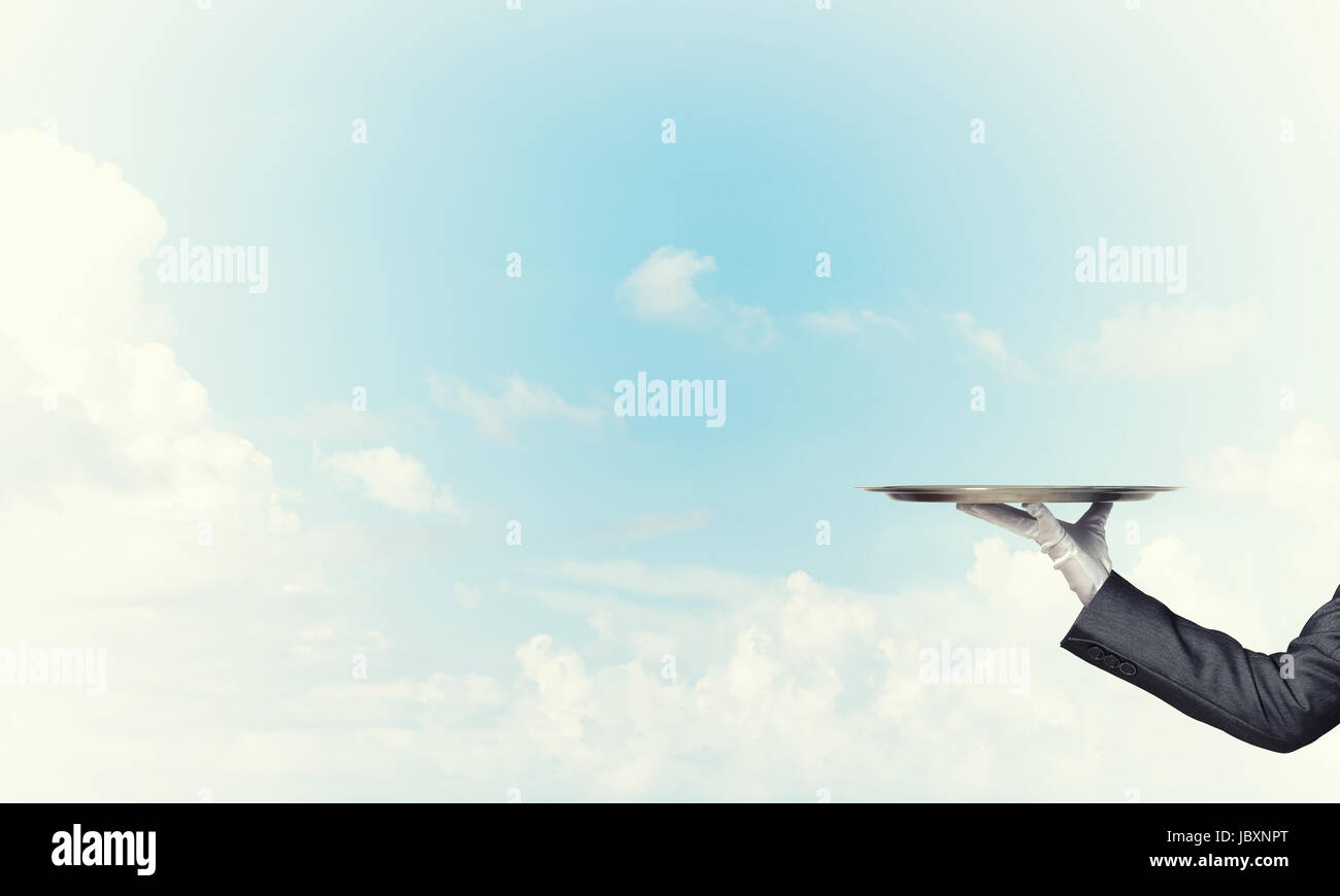 Butler hand in white glove presenting empty tray Stock Photo - Alamy