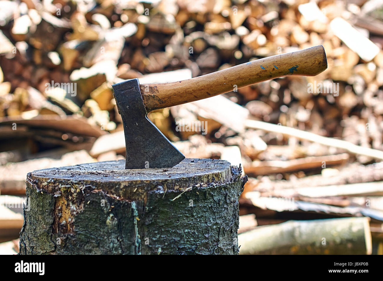 Axe in the stump Stock Photo - Alamy