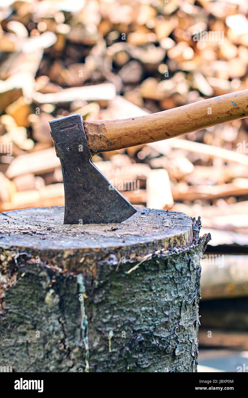 Axe in the stump Stock Photo - Alamy