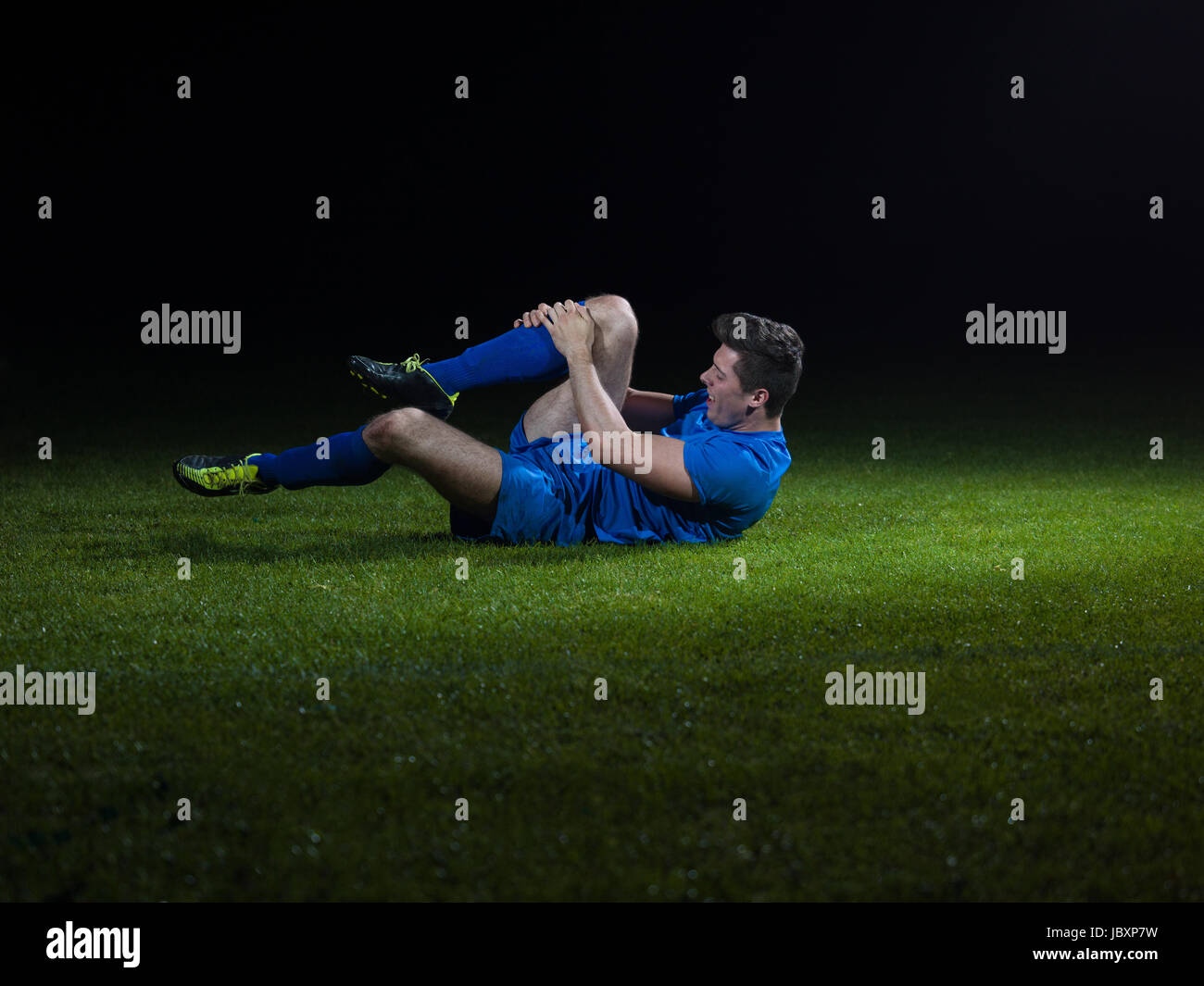 soccer player doing kick with ball on football stadium field isolated ...