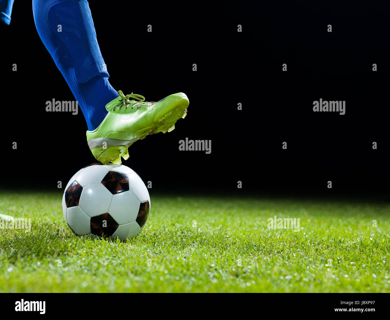 soccer player doing kick with ball on football stadium field isolated ...