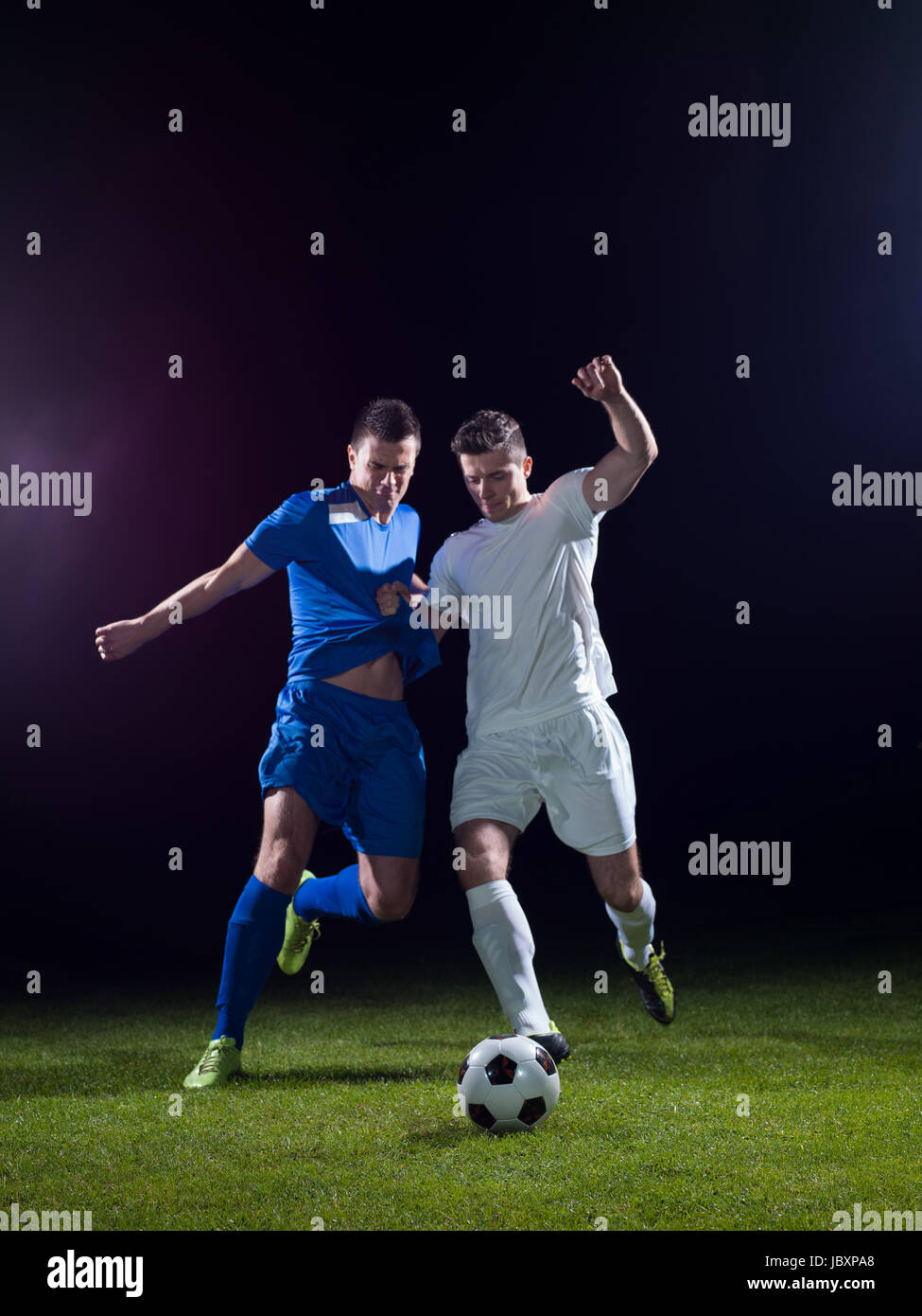 soccer player doing kick with ball on football stadium field isolated ...