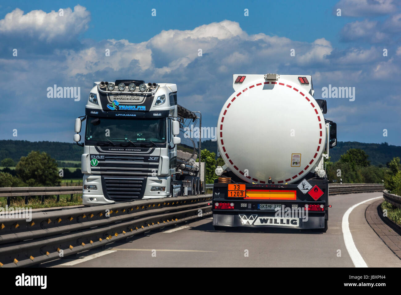 Two storage tanker trucks on road Germany highway Stock Photo - Alamy