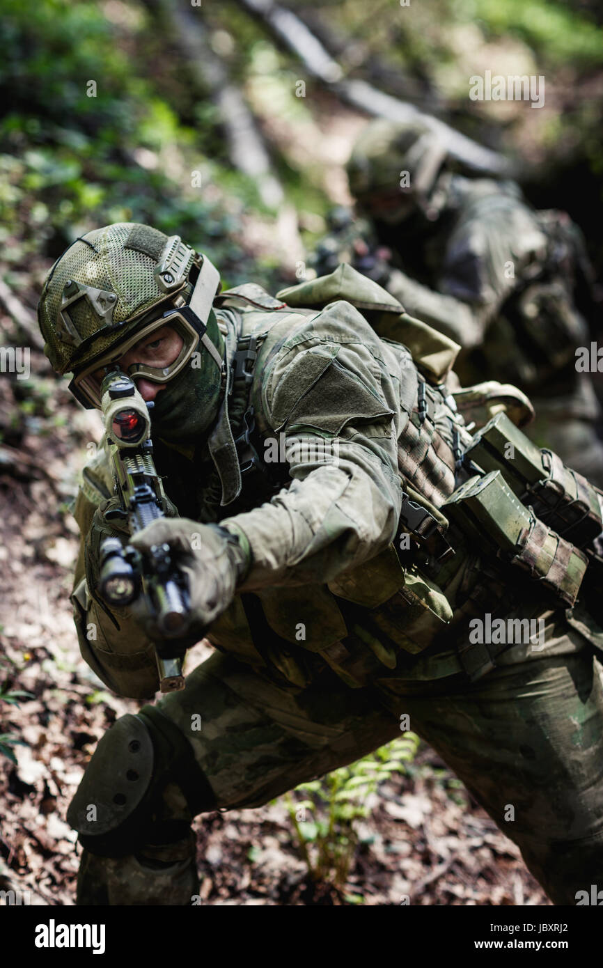 Soldiers exercise in daytime exploration at forest Stock Photo - Alamy