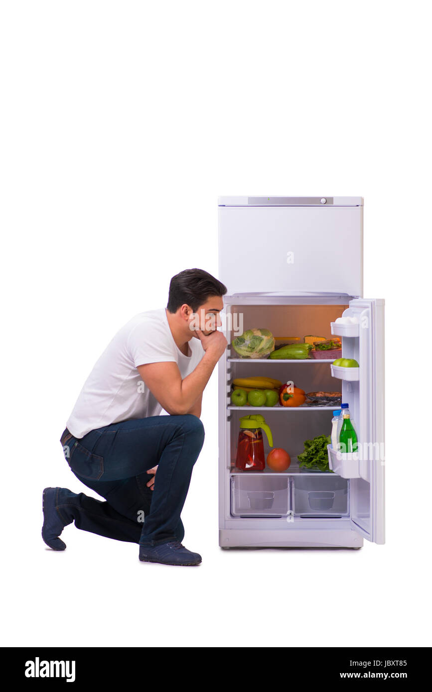 Man next to fridge full of food Stock Photo - Alamy