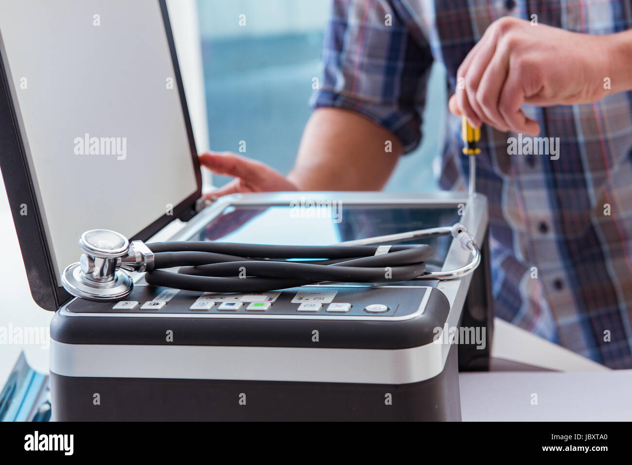 Repairman repairing broken color printer Stock Photo - Alamy