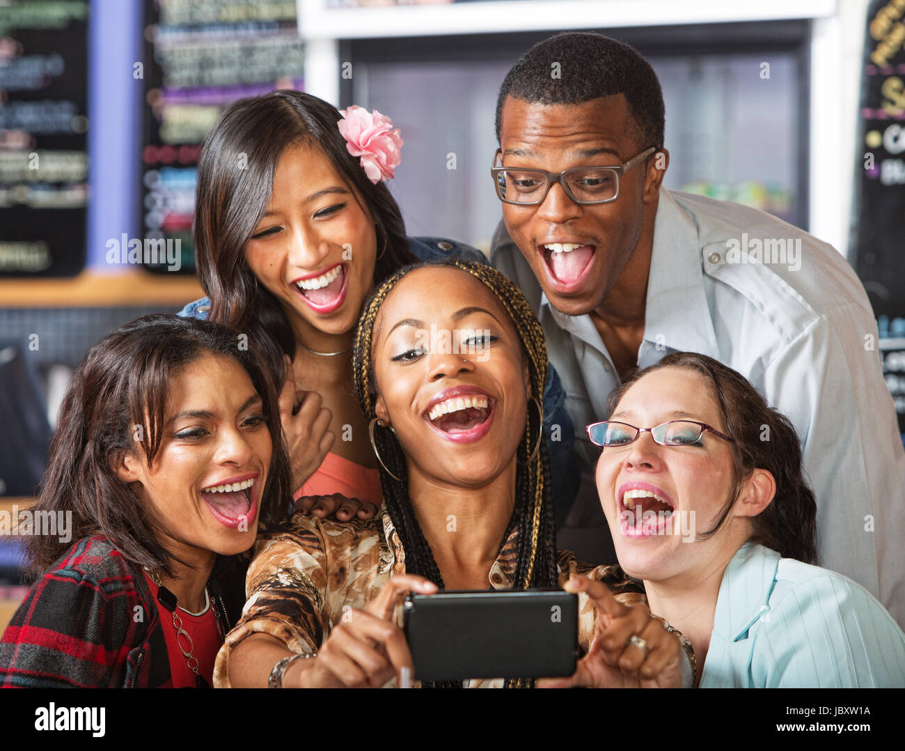 Group of students taking self-portrait with camera phone Stock Photo ...