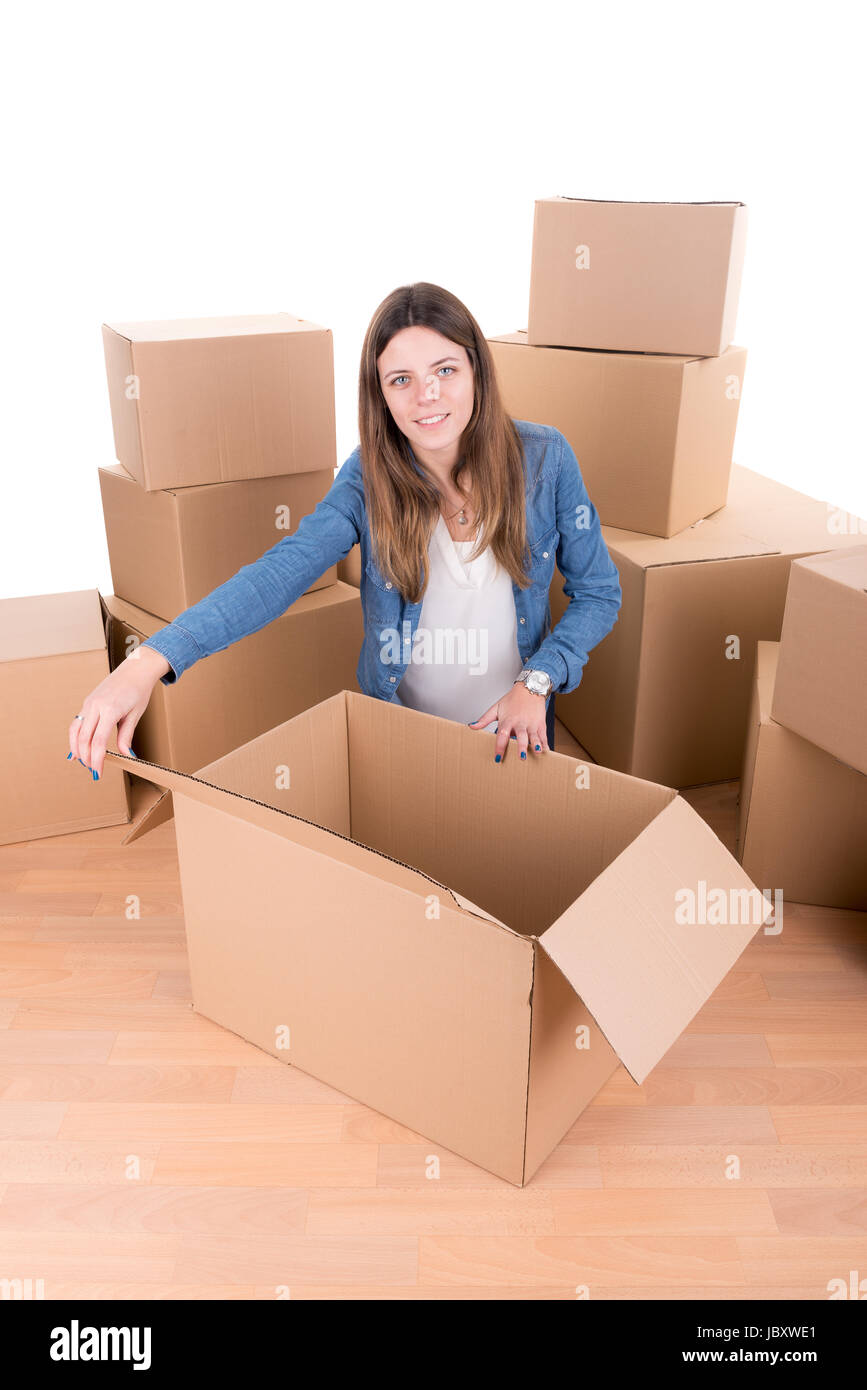 Beautiful girl with cardboard boxes unpacking in new home Stock Photo ...