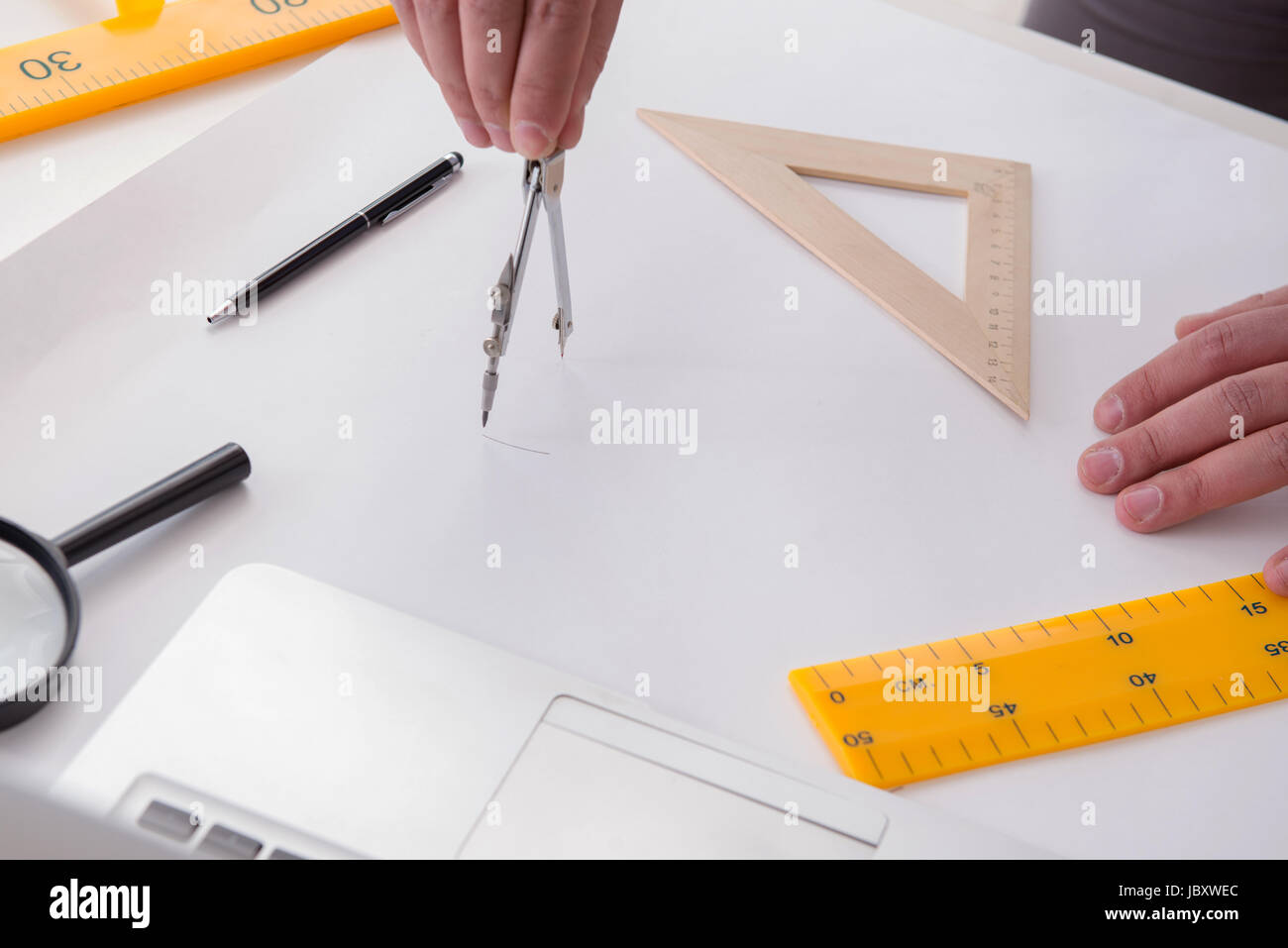 Male engineer working on drawings and blueprints Stock Photo - Alamy
