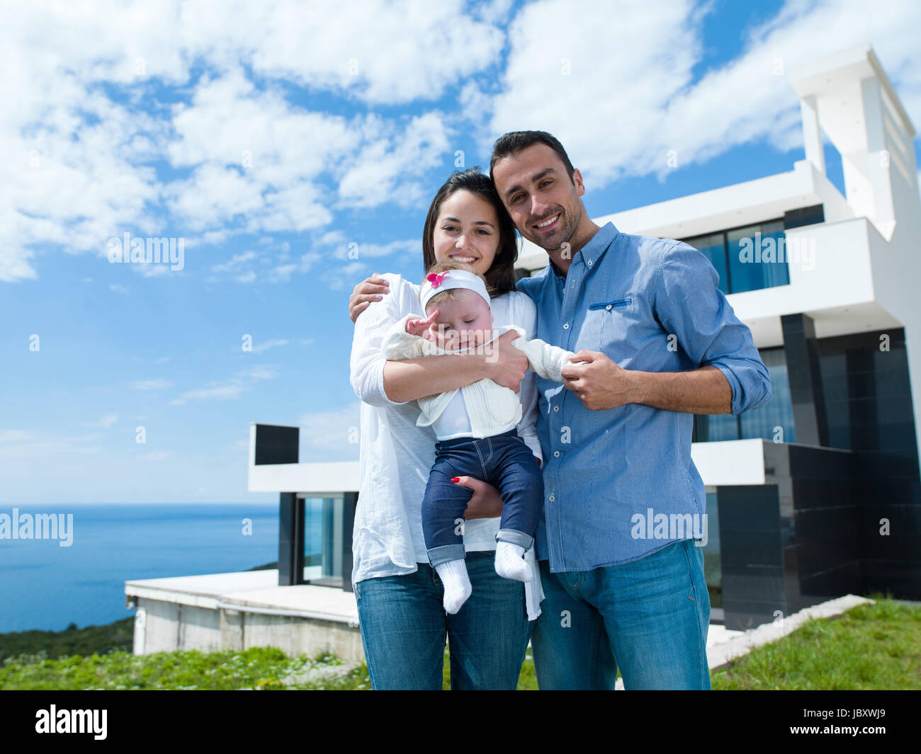 happy young family couple with beautiful new born baby have fun at ...