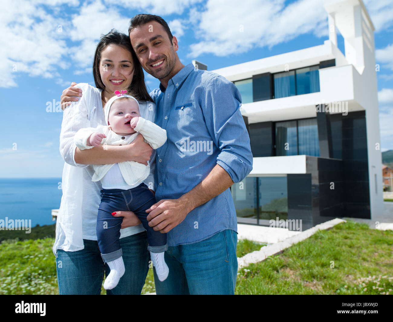 happy young family couple with beautiful new born baby have fun at ...