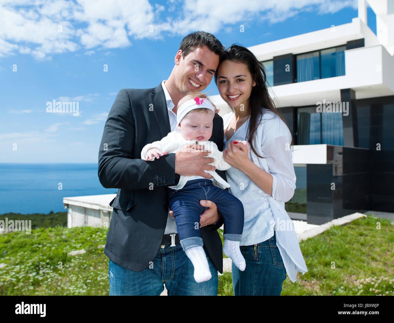 happy young family couple with beautiful new born baby have fun at ...