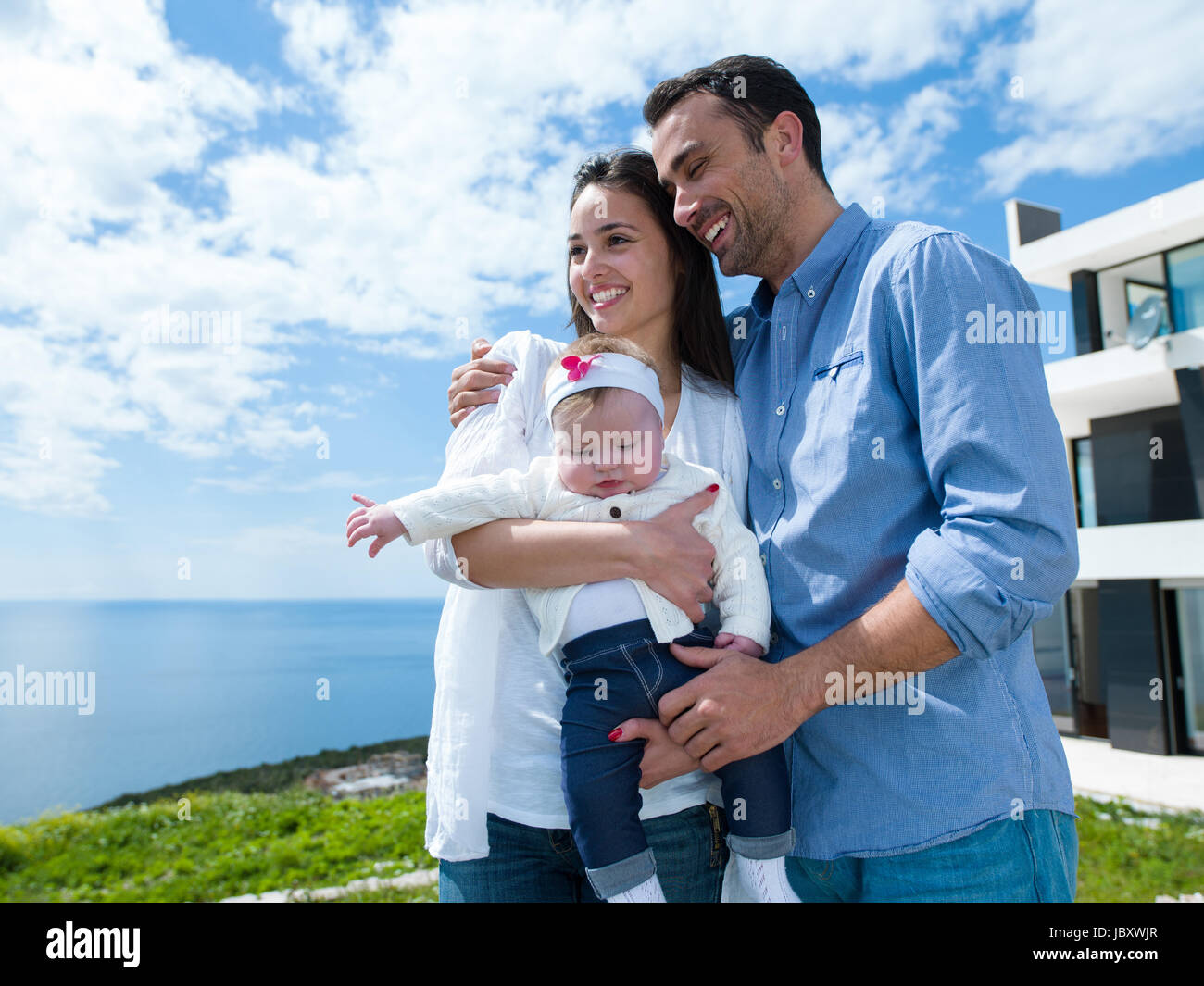 happy young family couple with beautiful new born baby have fun at ...