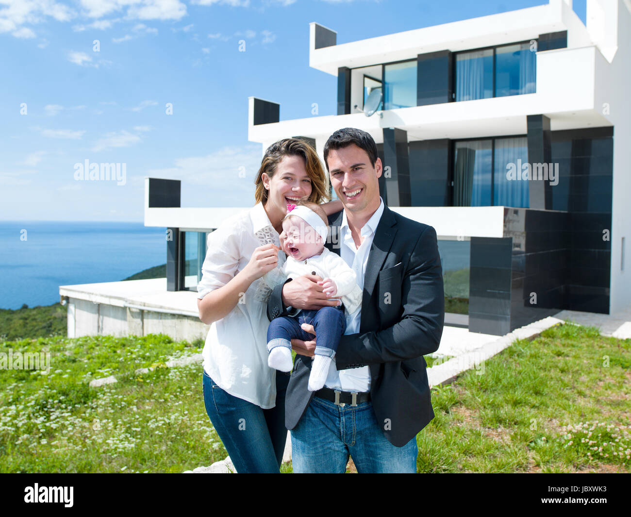 happy young family couple with beautiful new born baby have fun at ...