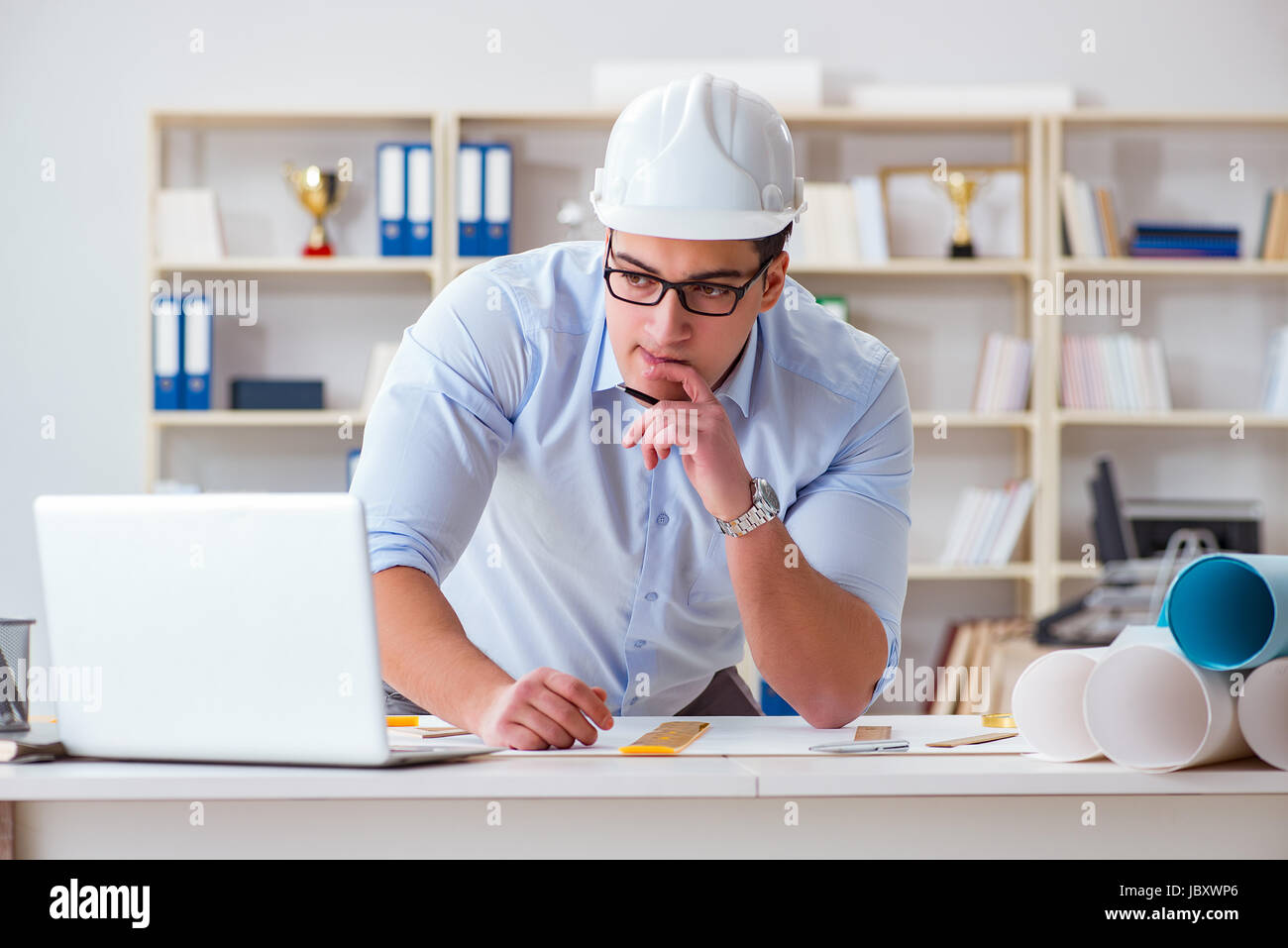 Male engineer working on drawings and blueprints Stock Photo - Alamy