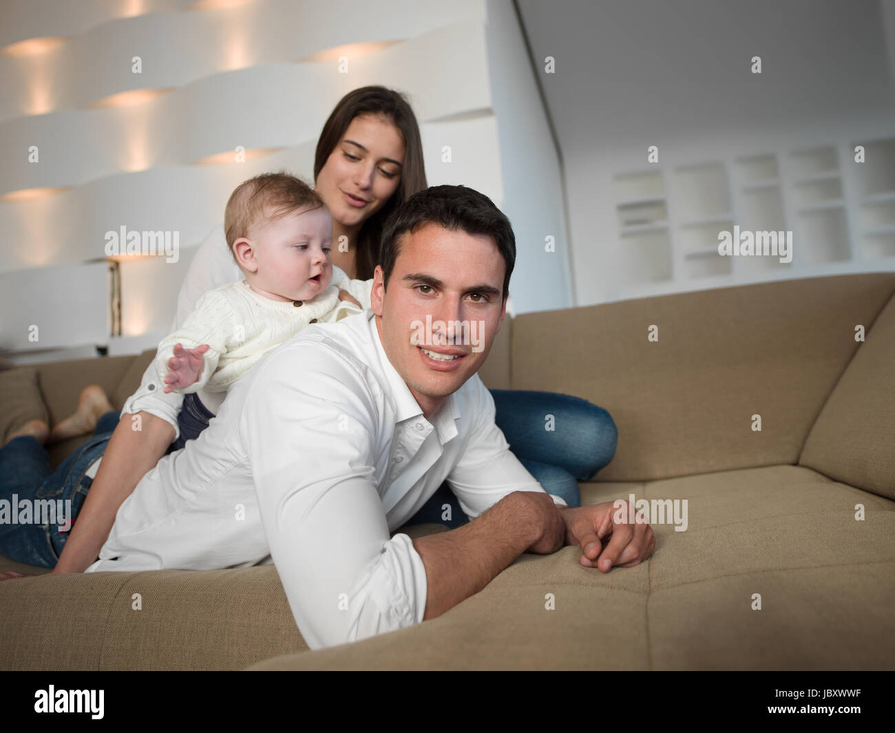 happy young family couple with beautiful new born baby have fun at ...