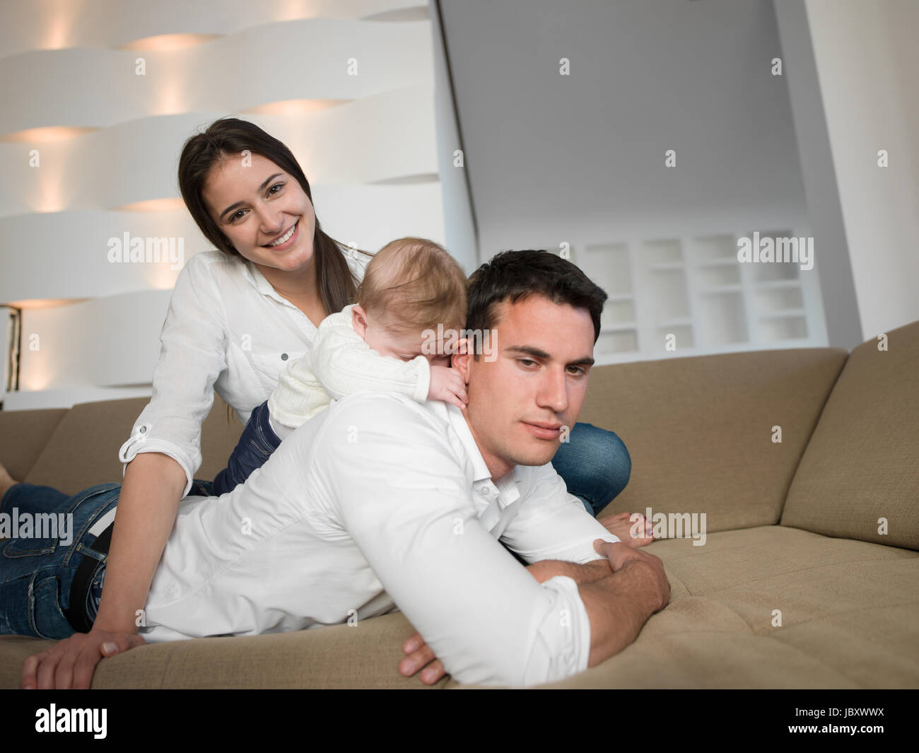 happy young family couple with beautiful new born baby have fun at ...