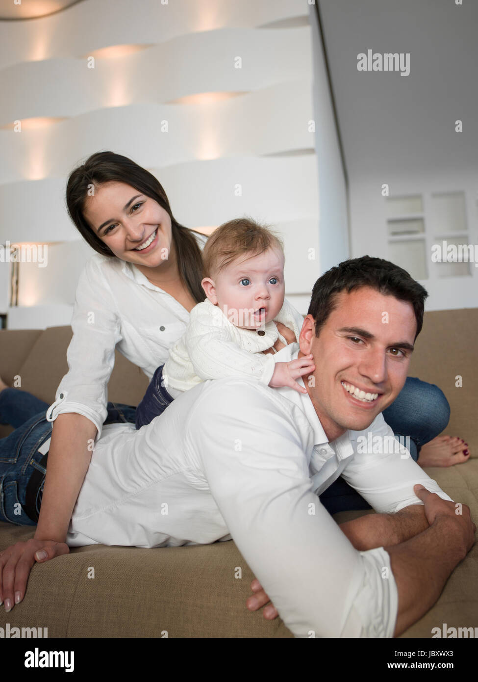 happy young family couple with beautiful new born baby have fun at ...