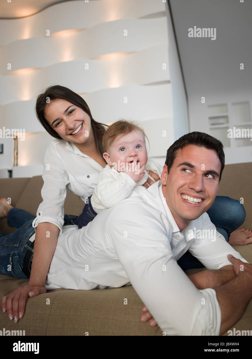 happy young family couple with beautiful new born baby have fun at ...